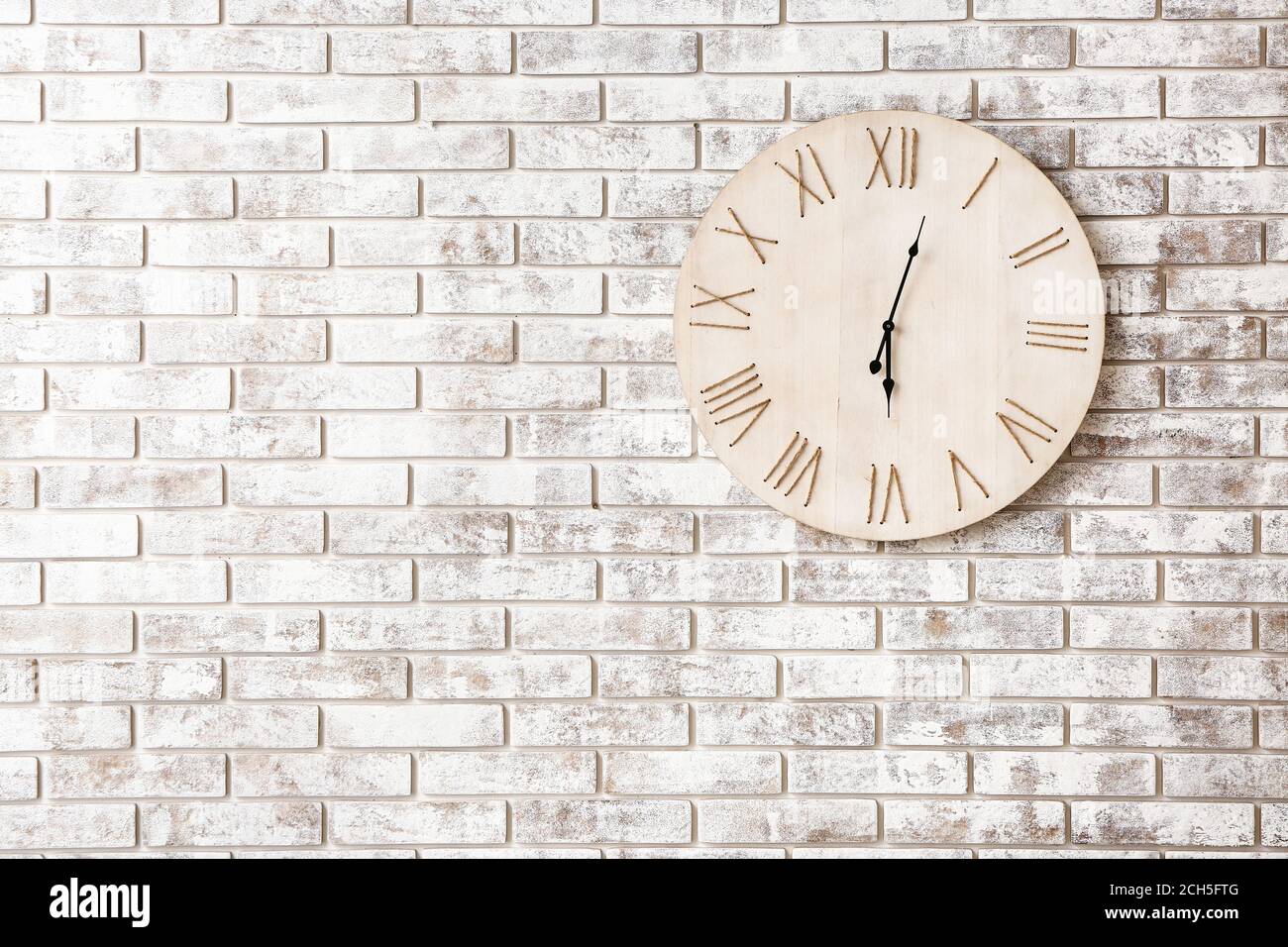 Simple clock on brick wall Stock Photo - Alamy