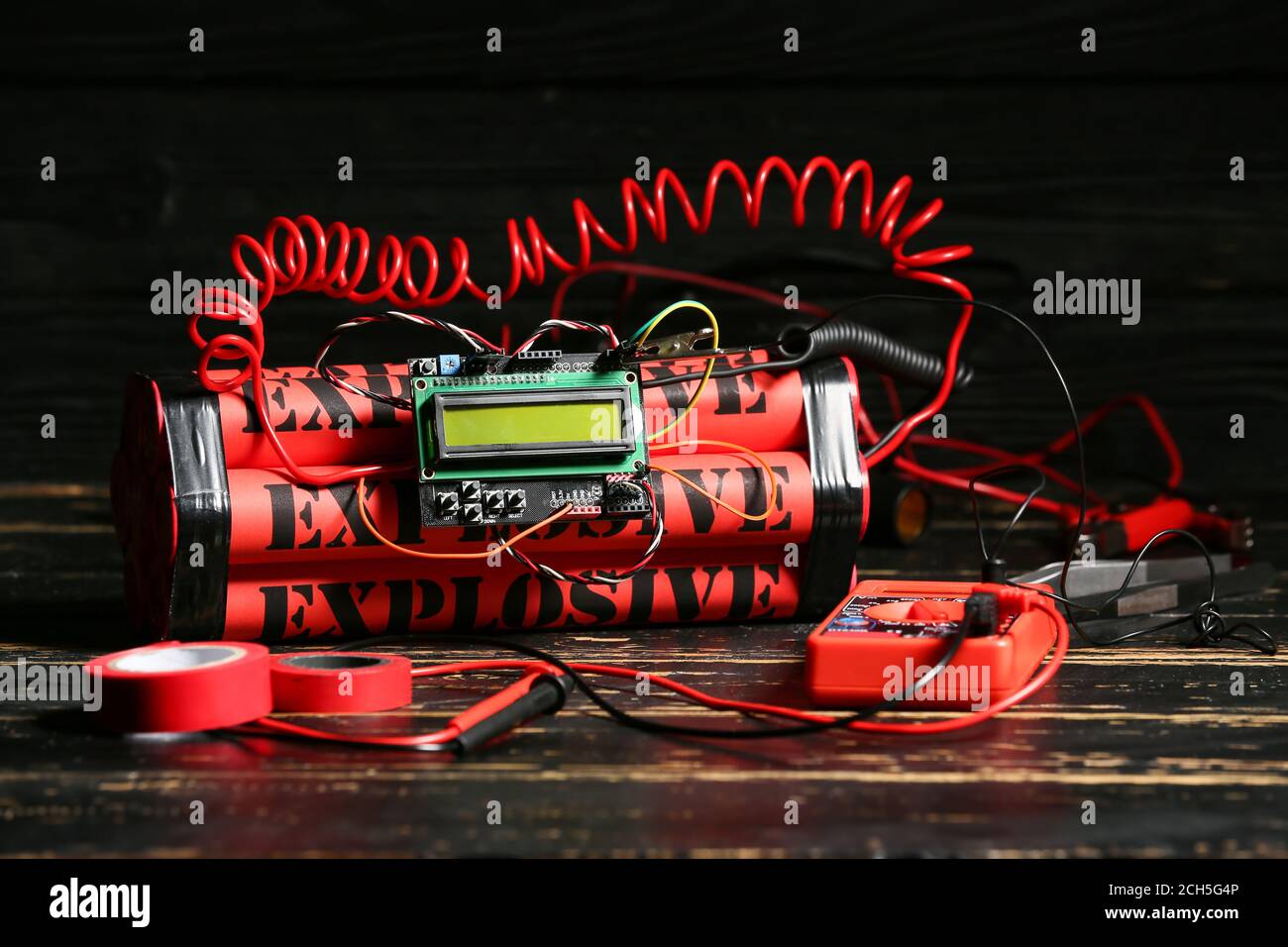Bomb and tools on table against dark background Stock Photo - Alamy