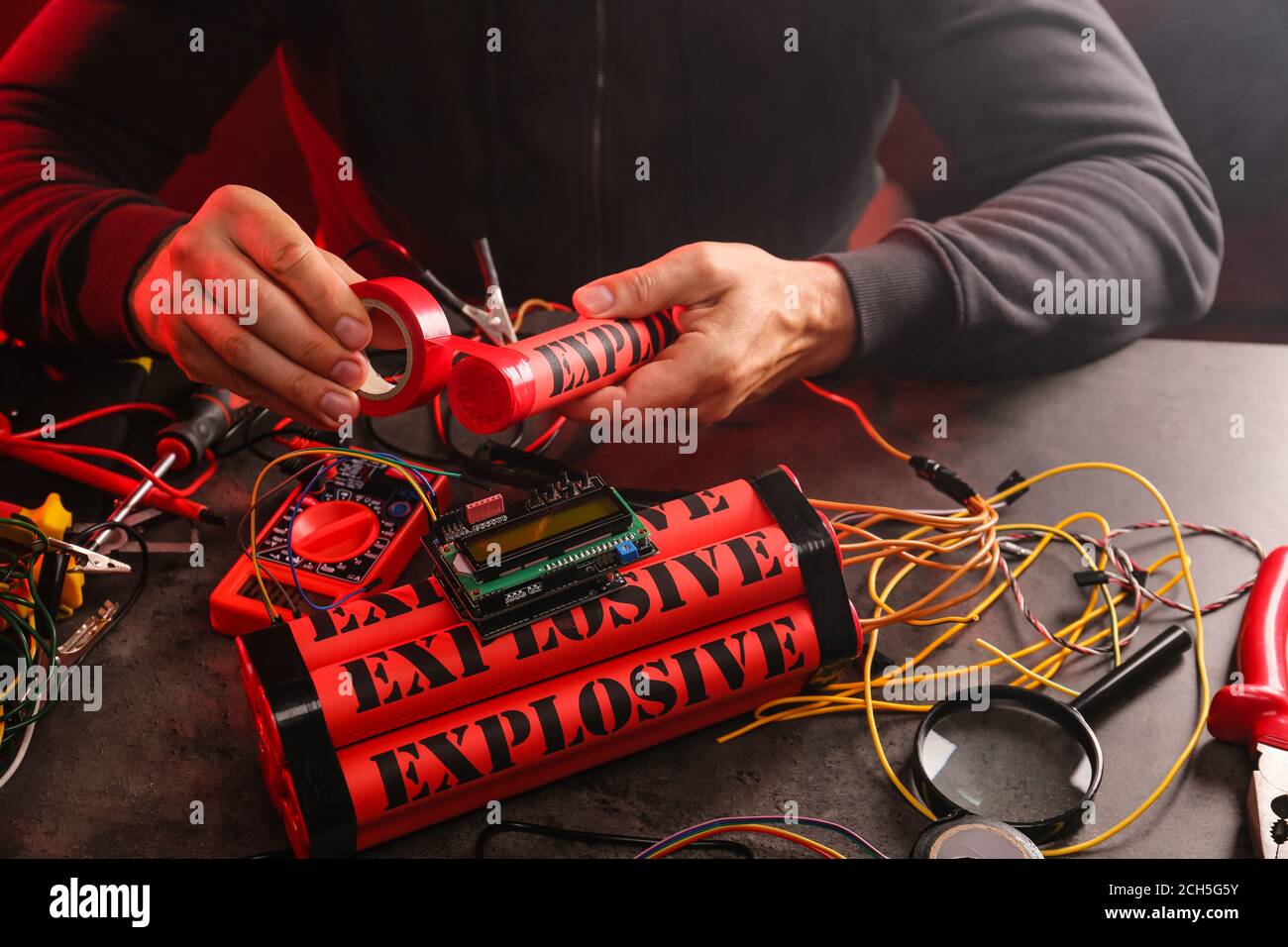 Terrorist making bomb at table Stock Photo - Alamy