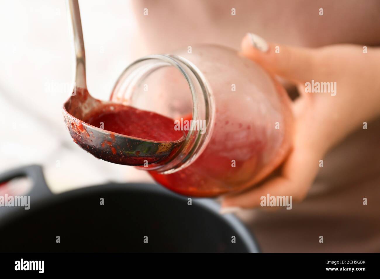 Hand pouring strawberry jam hi-res stock photography and images - Alamy