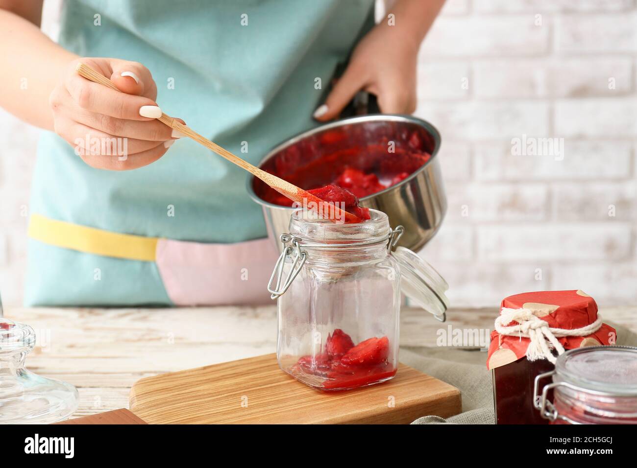 Hand pouring strawberry jam hi-res stock photography and images - Alamy
