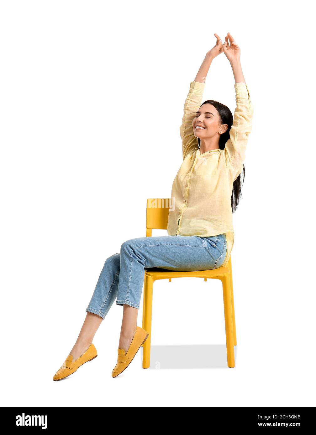 Young woman relaxing on chair against white background Stock Photo - Alamy