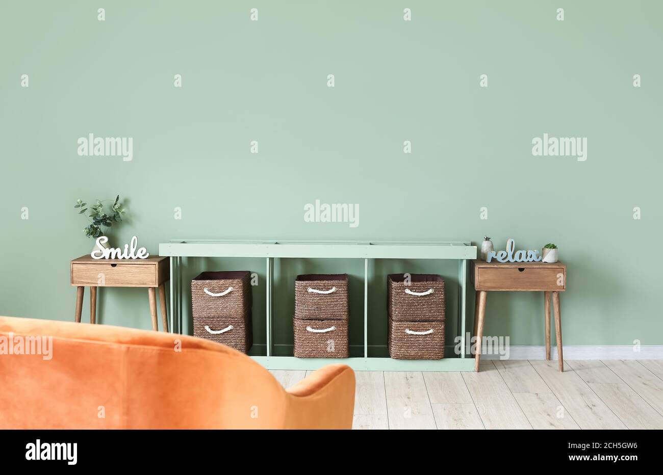 Shelf unit, sofa and tables in room Stock Photo - Alamy