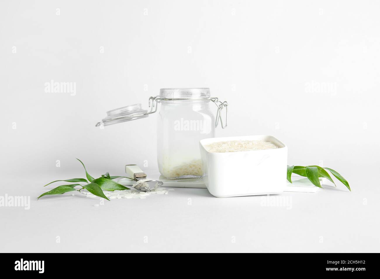 Jar of rice water on white background Stock Photo - Alamy
