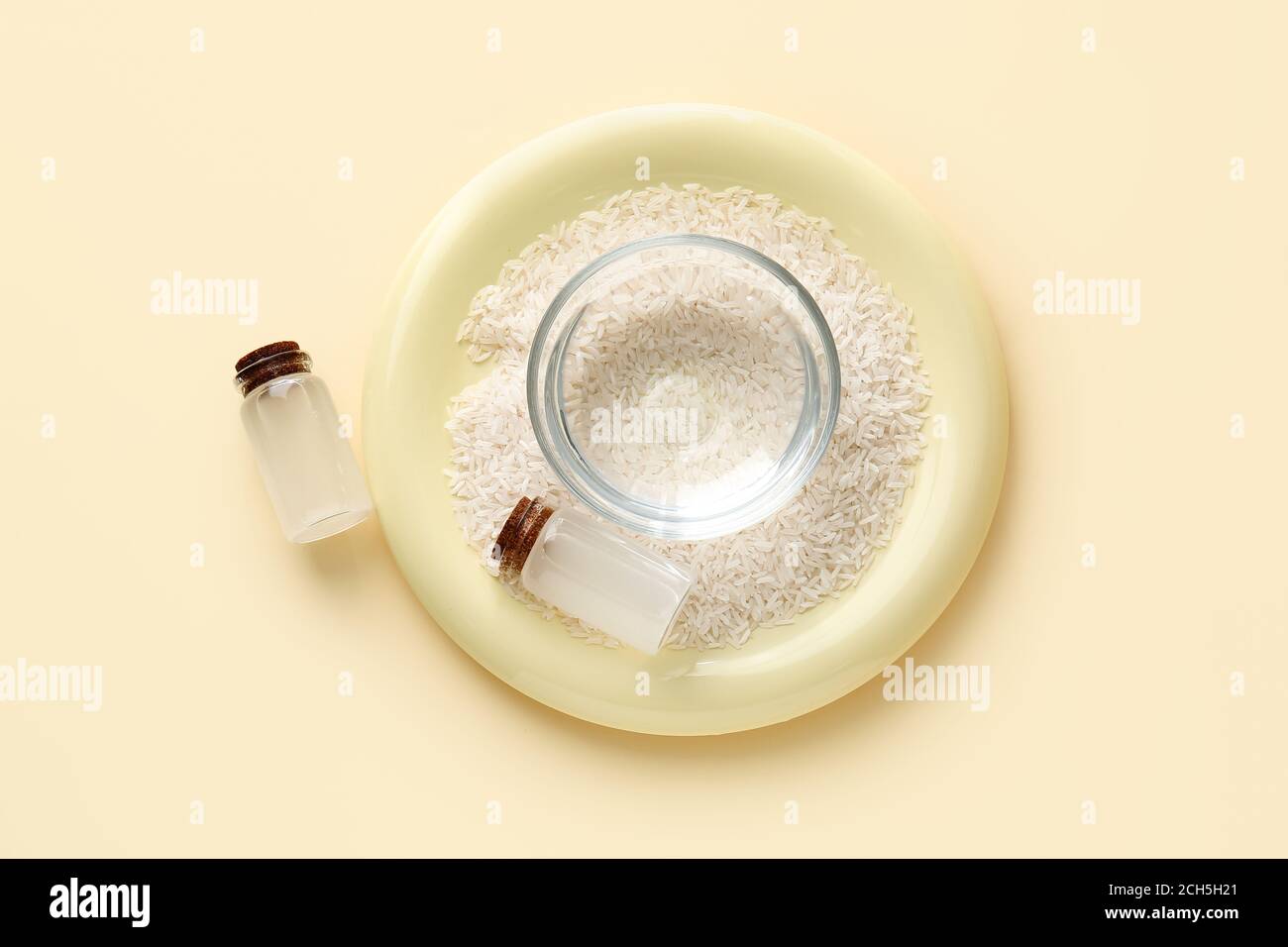 Bottles of rice water on color background Stock Photo - Alamy