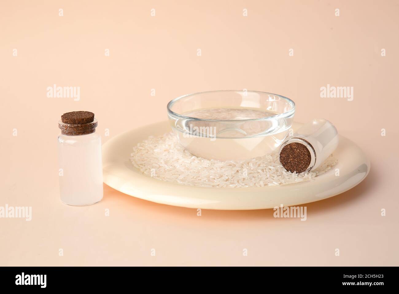 Bottles of rice water on color background Stock Photo - Alamy