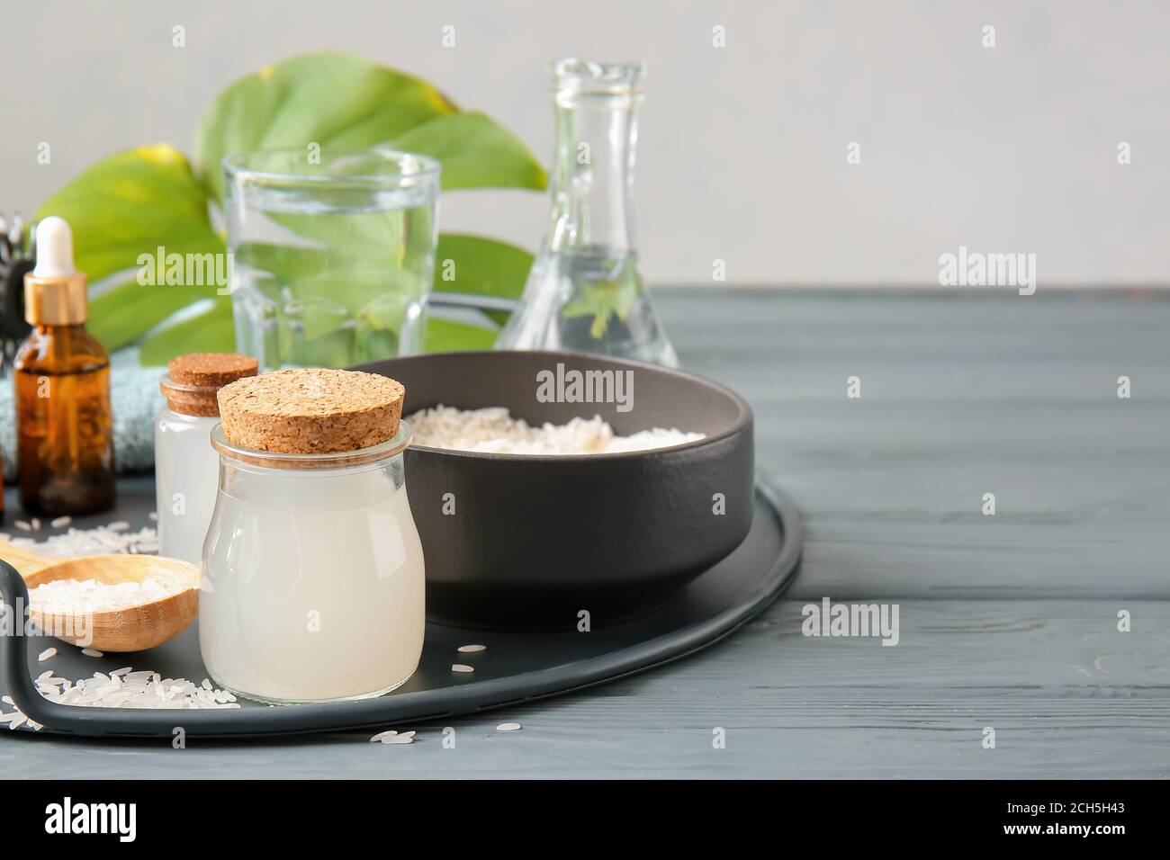 Composition with healthy rice water on table Stock Photo - Alamy
