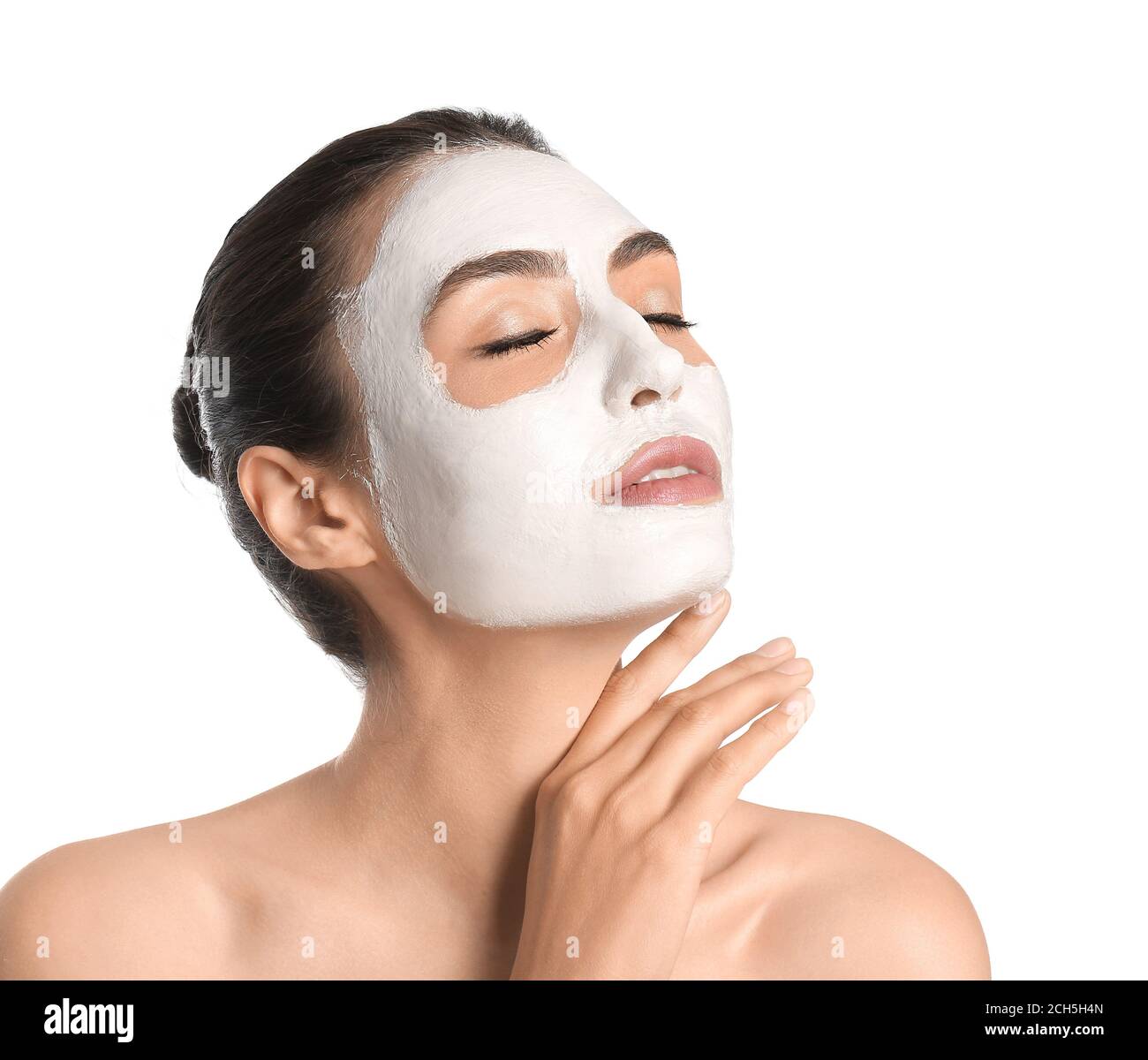 Beautiful young woman with mask on her face against white background ...