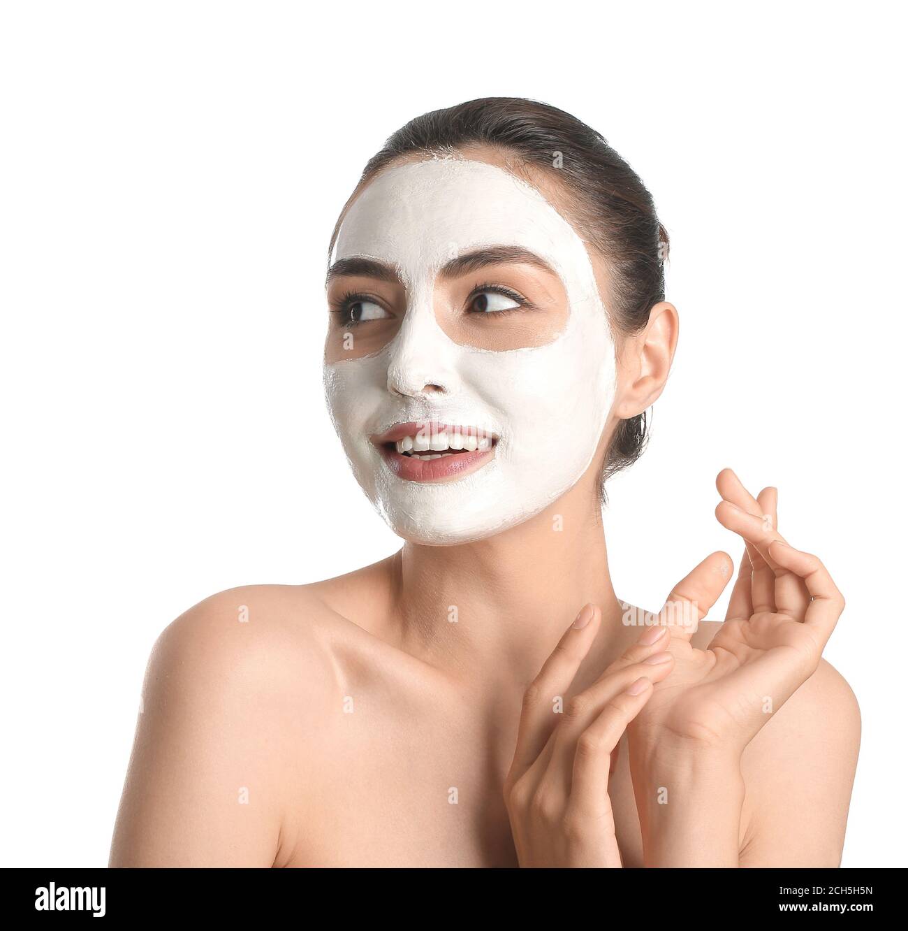 Beautiful young woman with mask on her face against white background ...