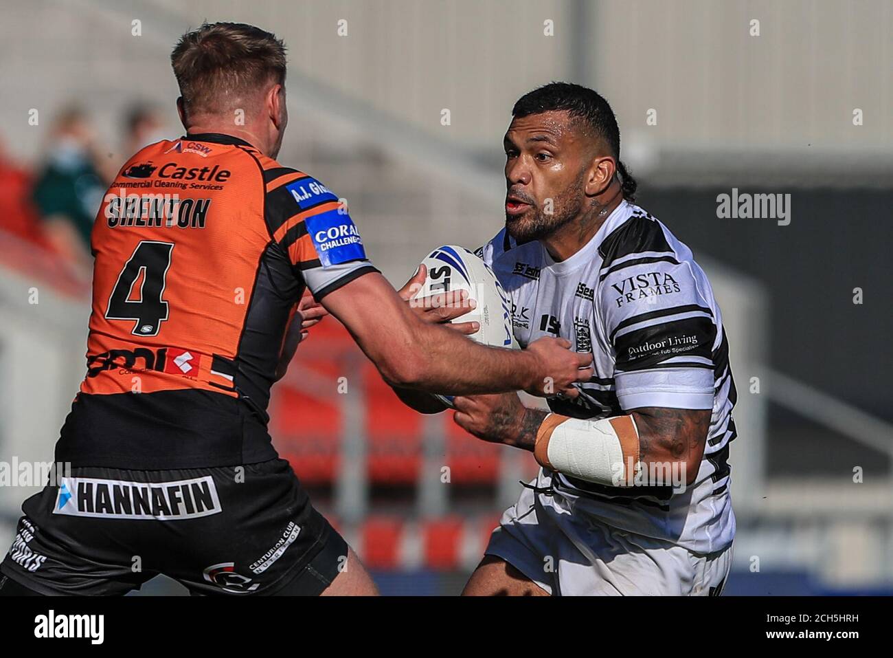 Manu Ma'u (12) of Hull FC looks for a way past Michael Shenton (4) of ...
