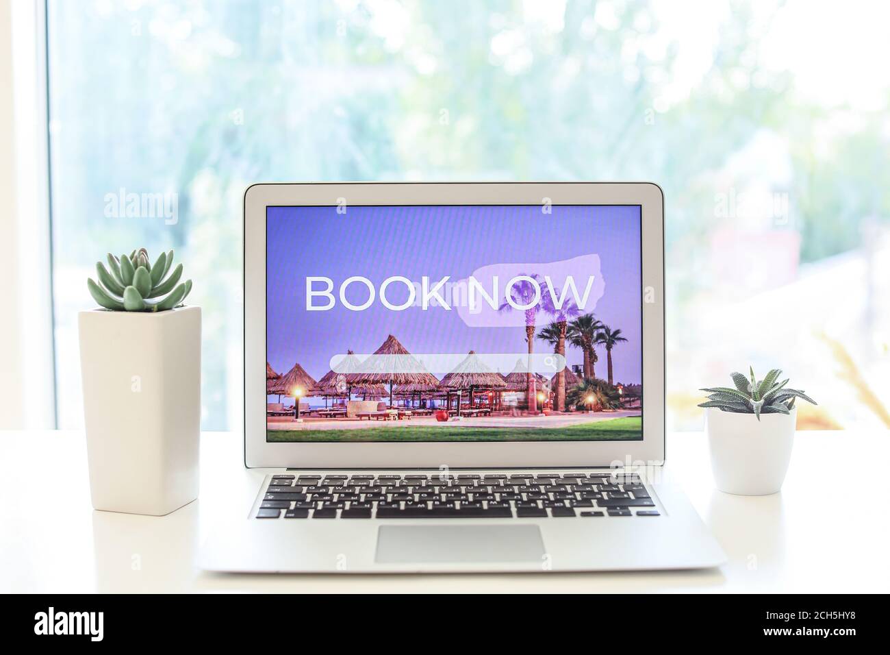 Open page of online booking service on screen of laptop on table Stock ...