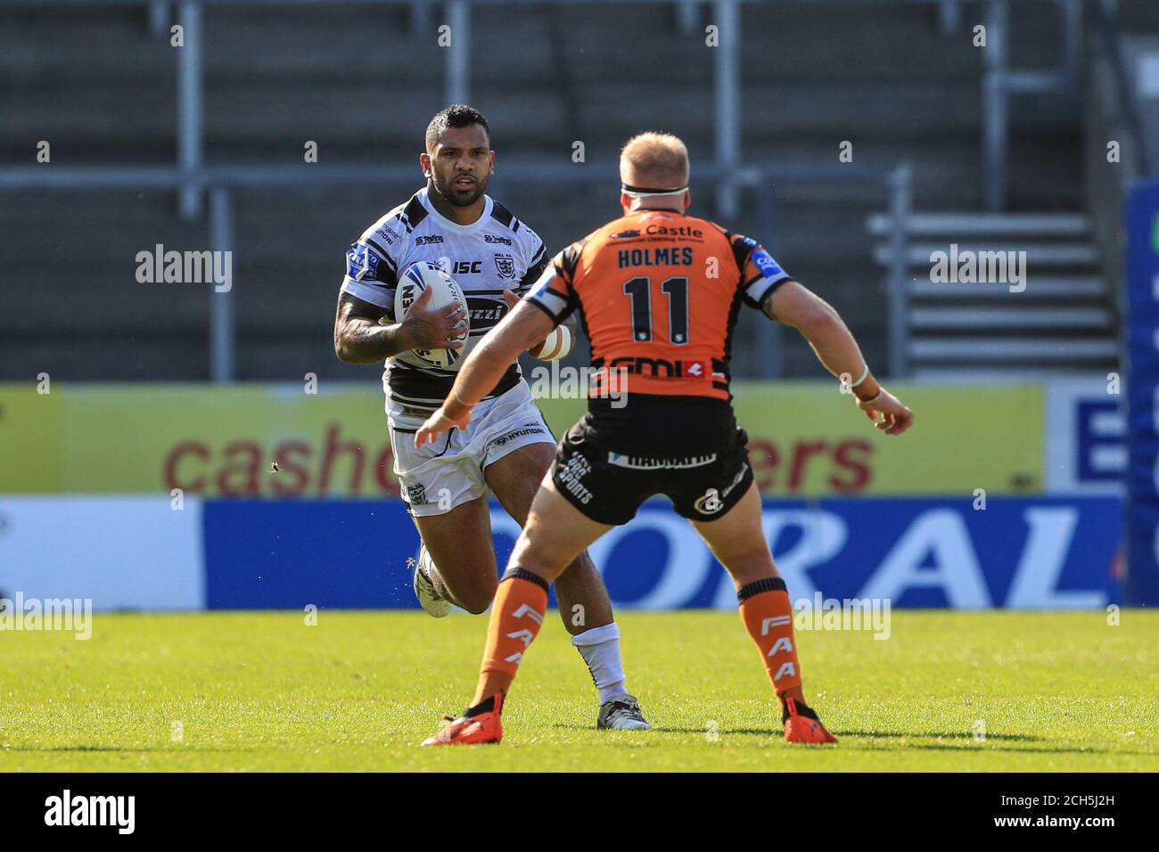 Manu Ma'u (12) of Hull FC looks for a way past Oliver Holmes (11) of ...