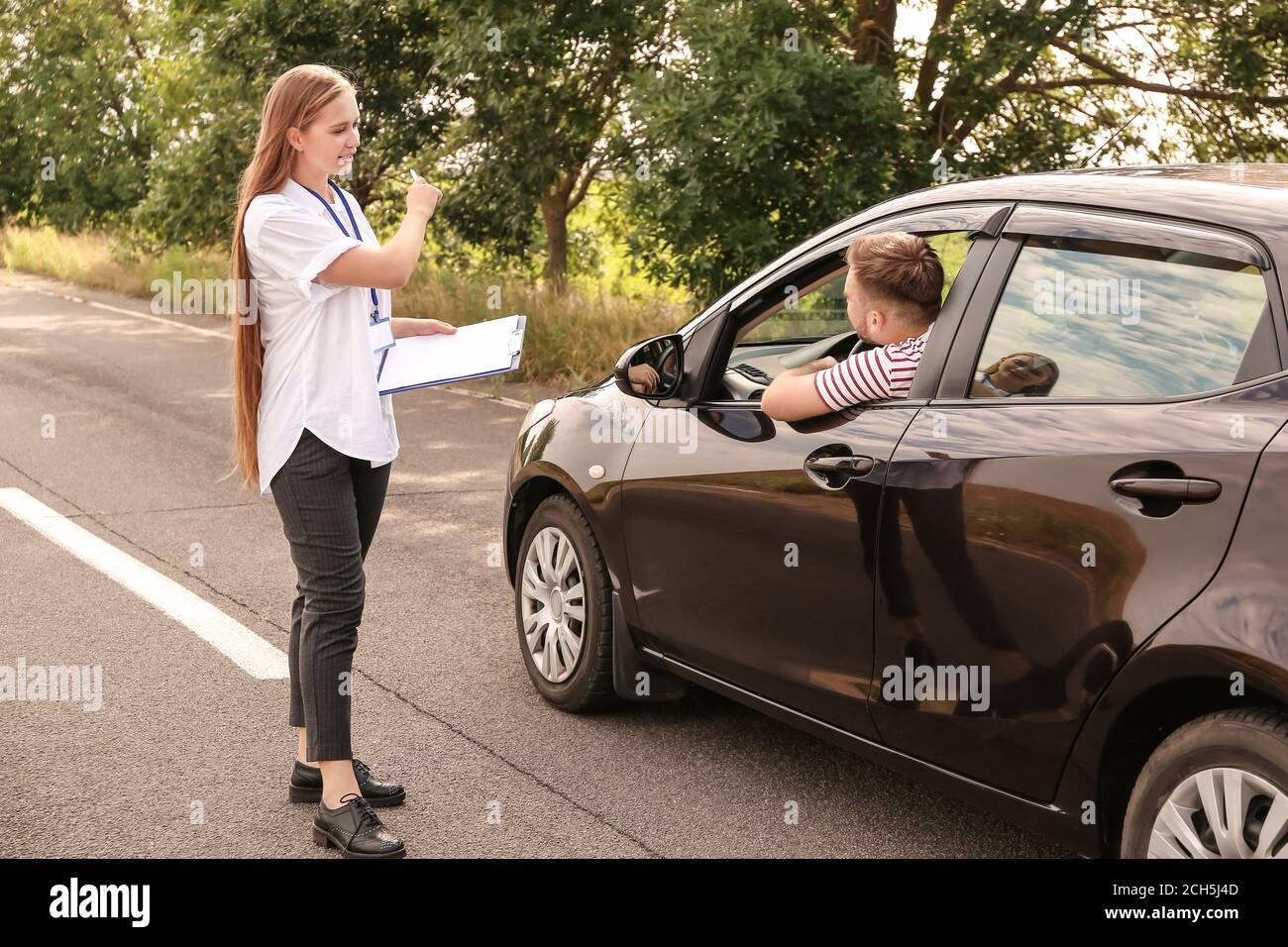 Instructor conducting driver licence test Stock Photo - Alamy