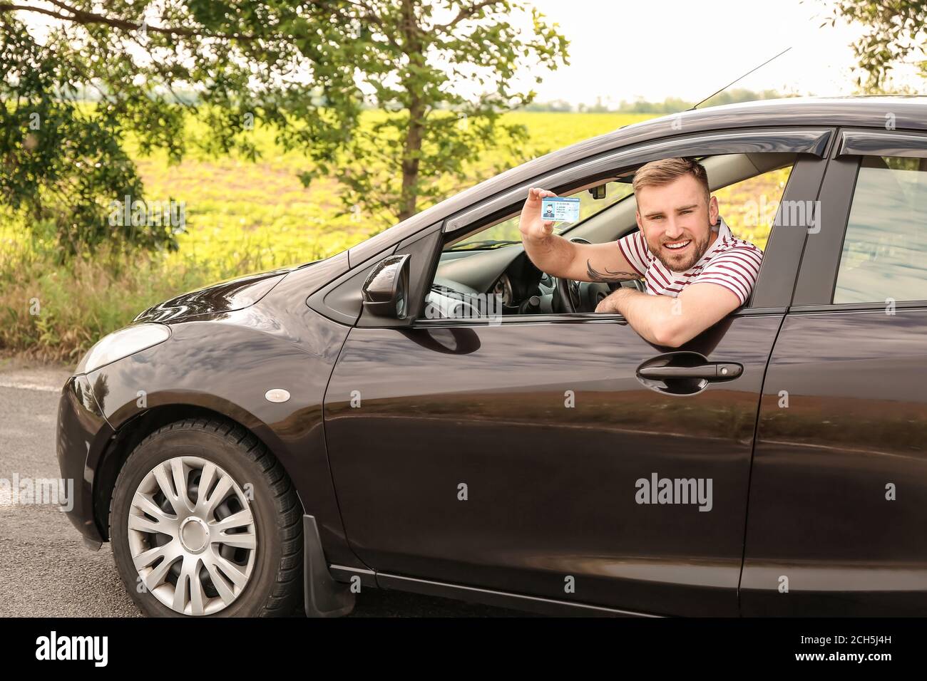 Happy young man after successful passing of driving license test Stock ...