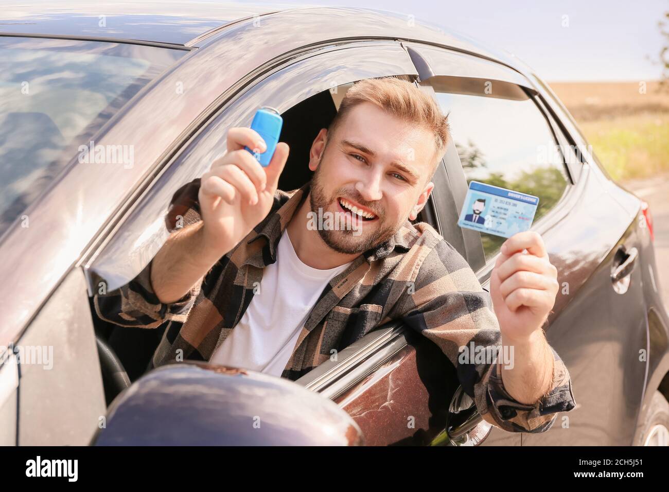 Happy young man after successful passing of driving license test Stock ...