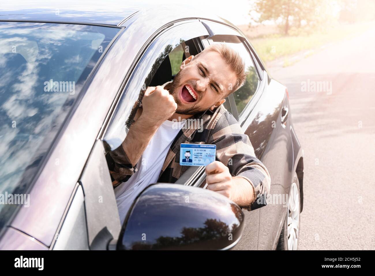 Happy young man after successful passing of driving license test Stock ...