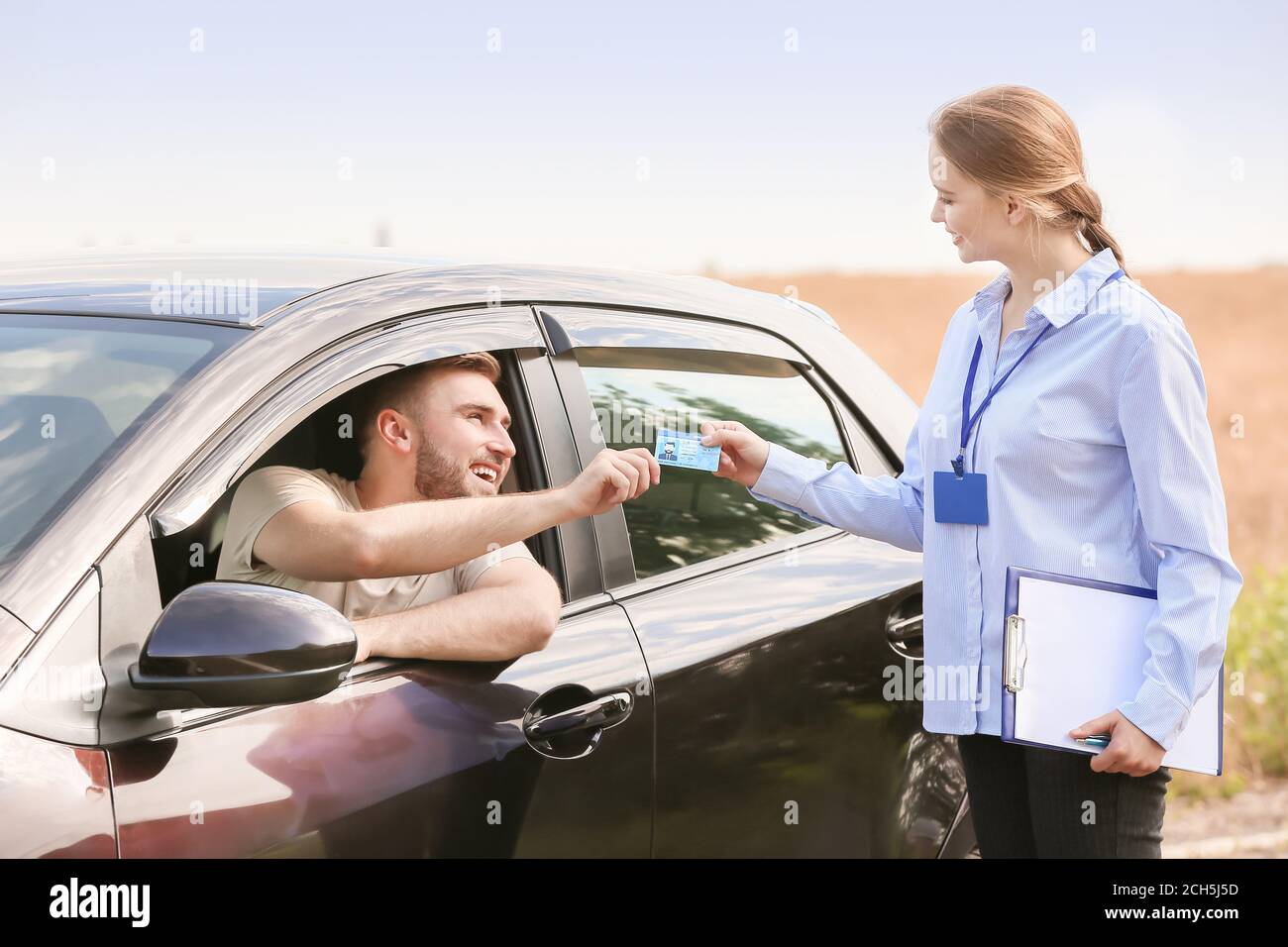 Man getting driver licence after passing test Stock Photo - Alamy