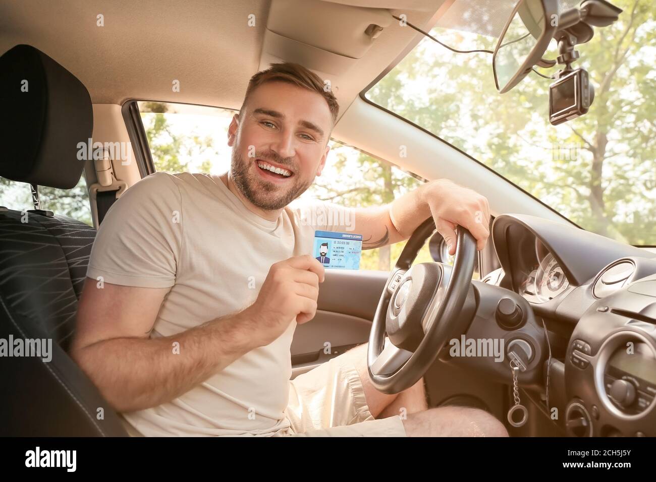 Happy young man after successful passing of driving license test Stock ...