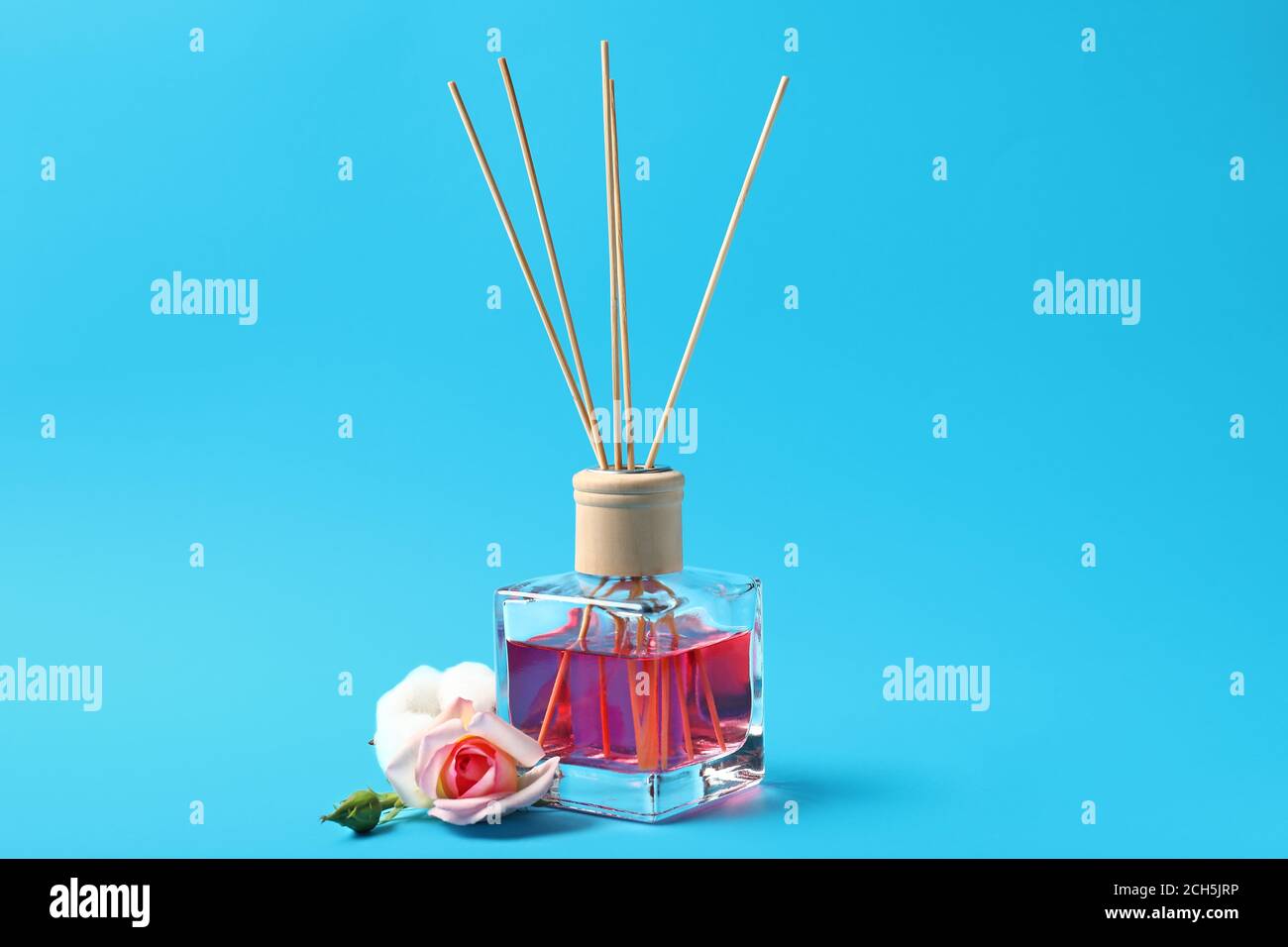 Floral reed diffuser on color background Stock Photo - Alamy