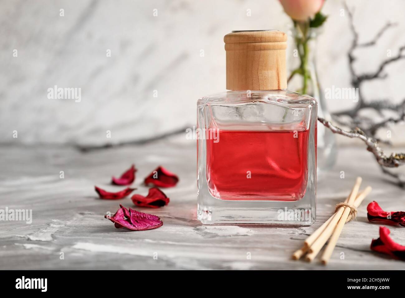 Reed diffuser on table against light background Stock Photo - Alamy