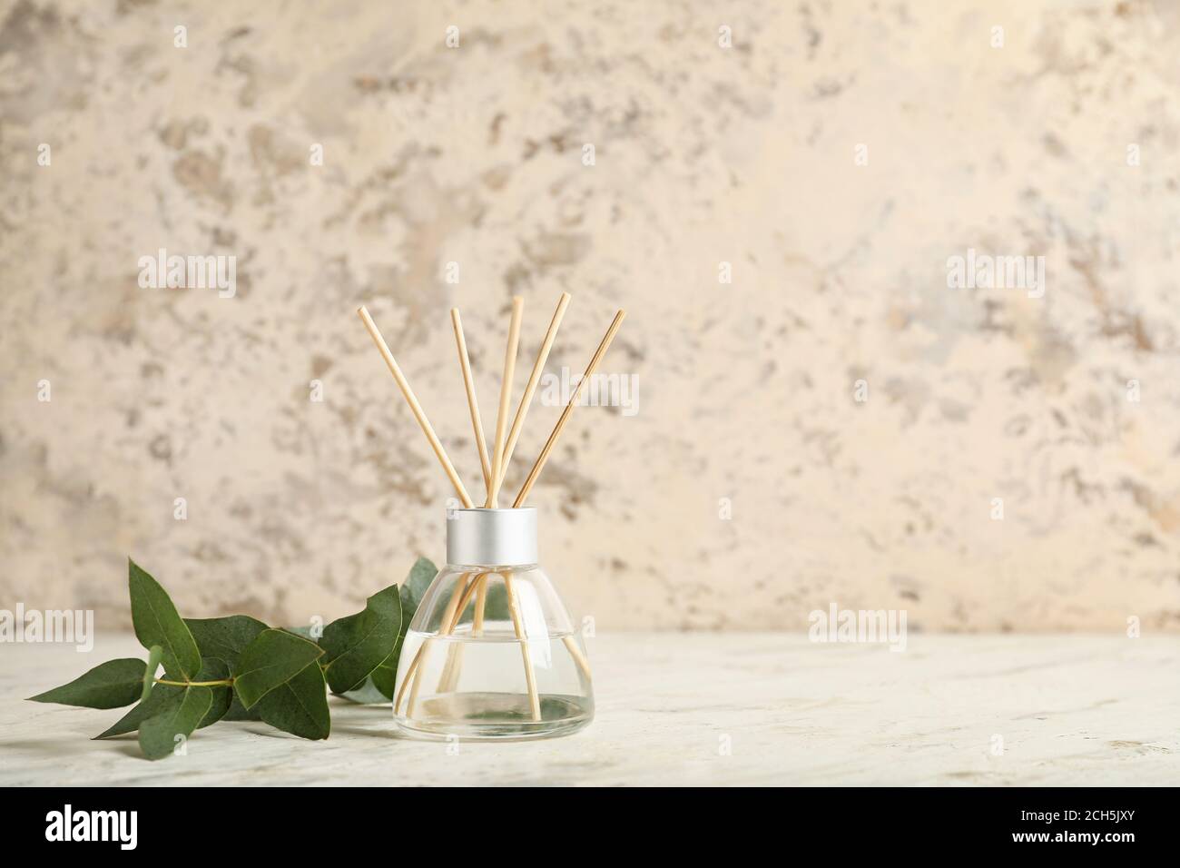 Reed diffuser and eucalyptus on table Stock Photo - Alamy
