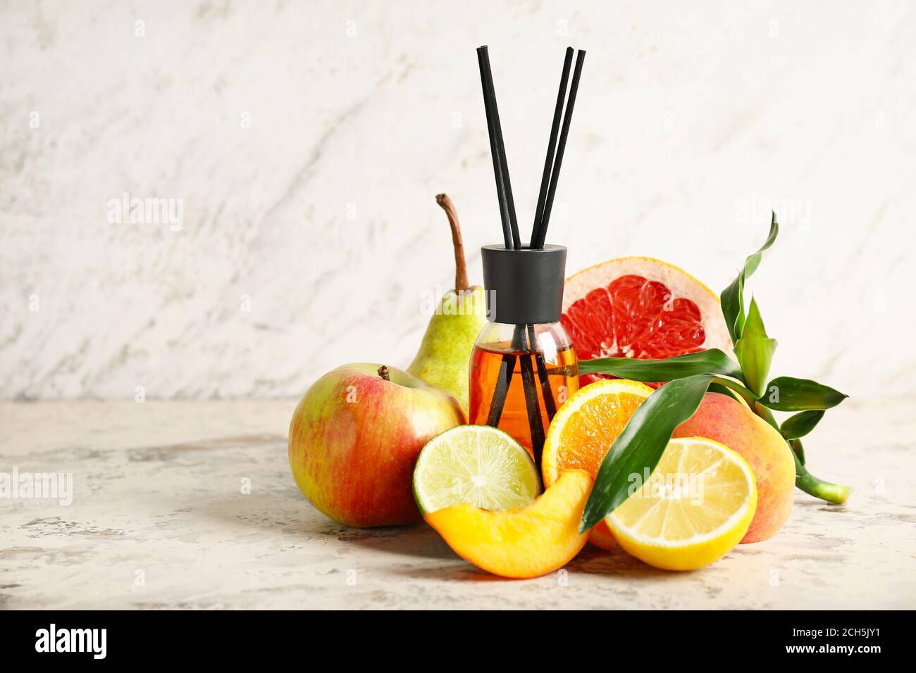 Fruit reed diffuser on table Stock Photo - Alamy