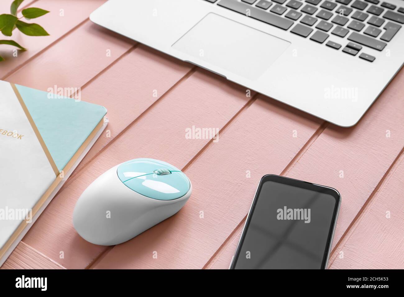 Modern PC mouse, smartphone and laptop on table Stock Photo - Alamy