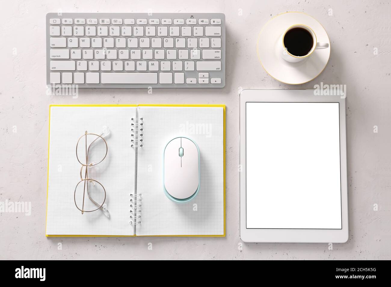 Modern tablet computer, keyboard, notebook, coffee and PC mouse on ...