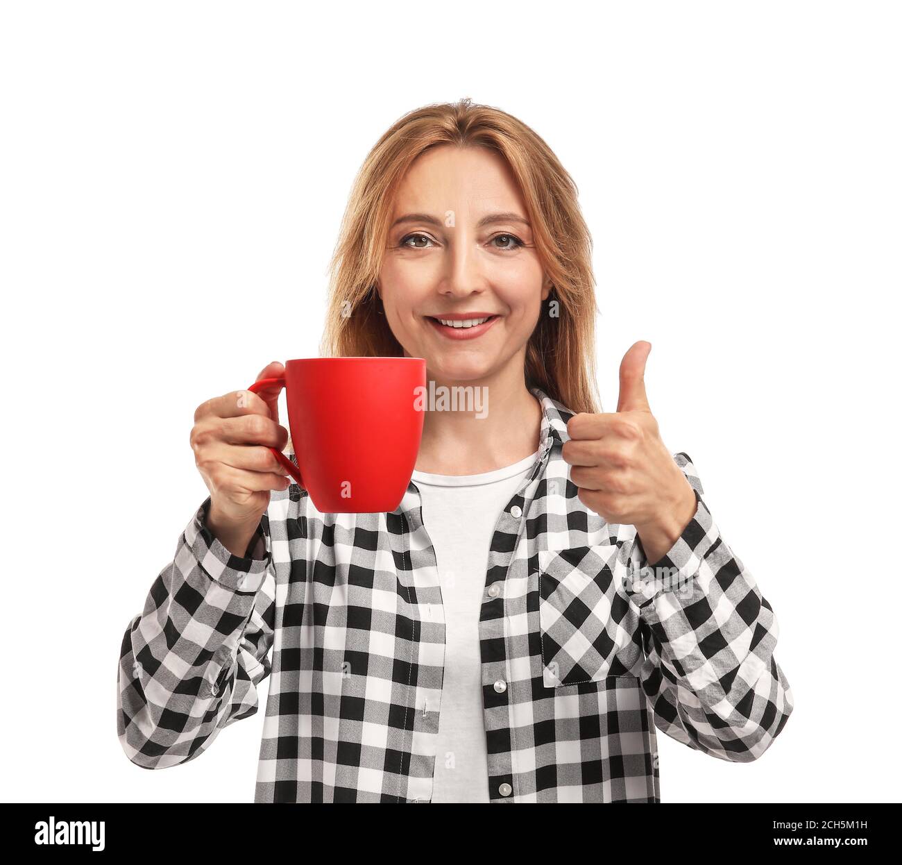 Beautiful woman with cup of tea showing thumb-up gesture on white ...