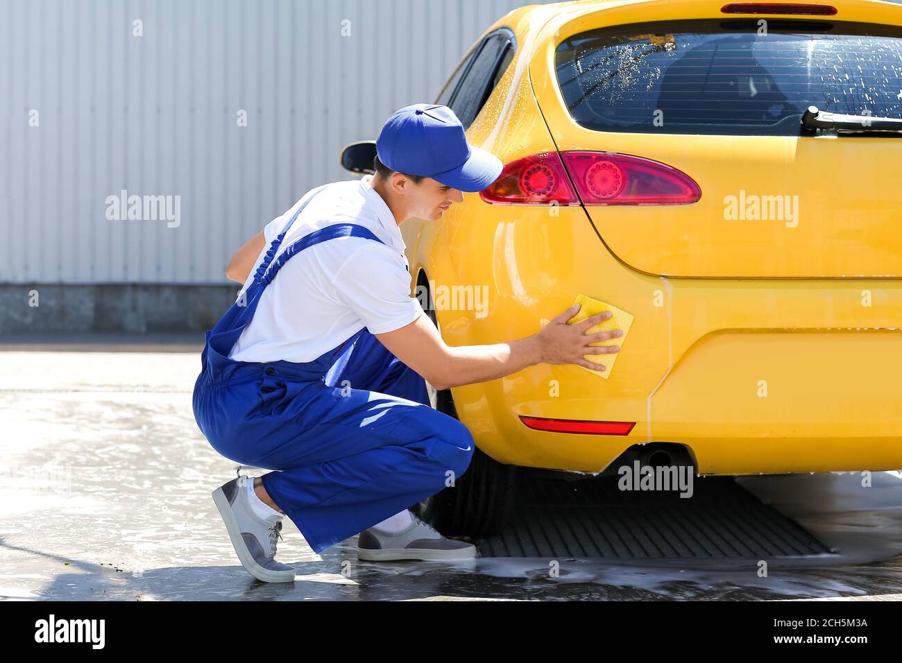 Worker of car wash cleaning modern automobile Stock Photo - Alamy