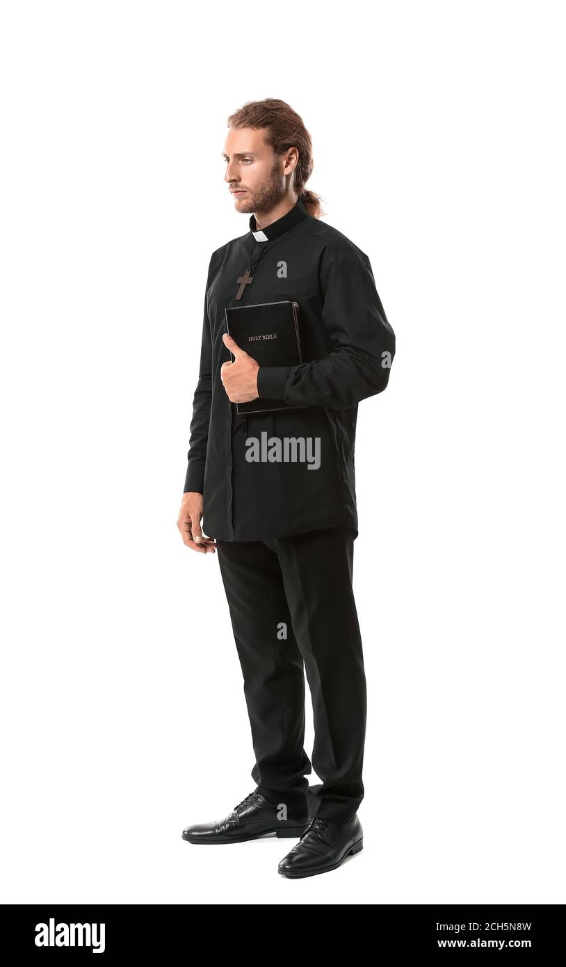 Handsome priest with Bible on white background Stock Photo - Alamy