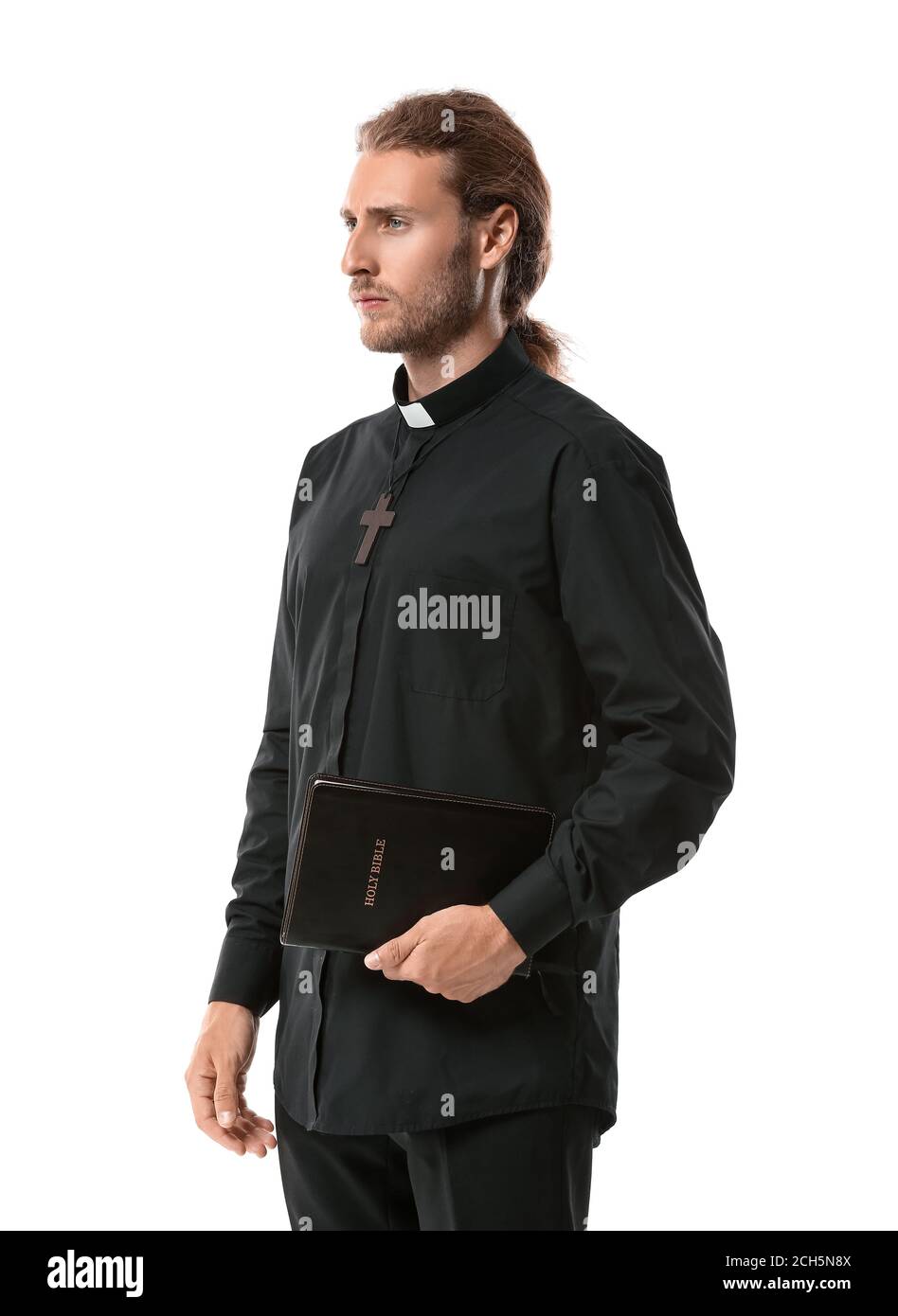 Handsome priest with Bible on white background Stock Photo - Alamy