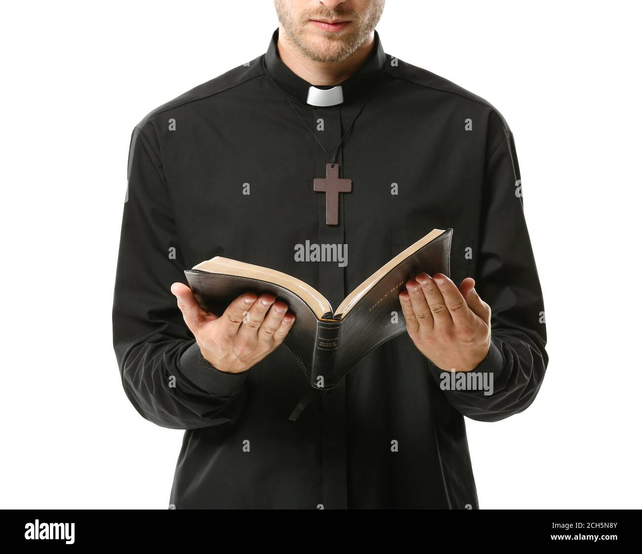Handsome priest with Bible on white background Stock Photo - Alamy