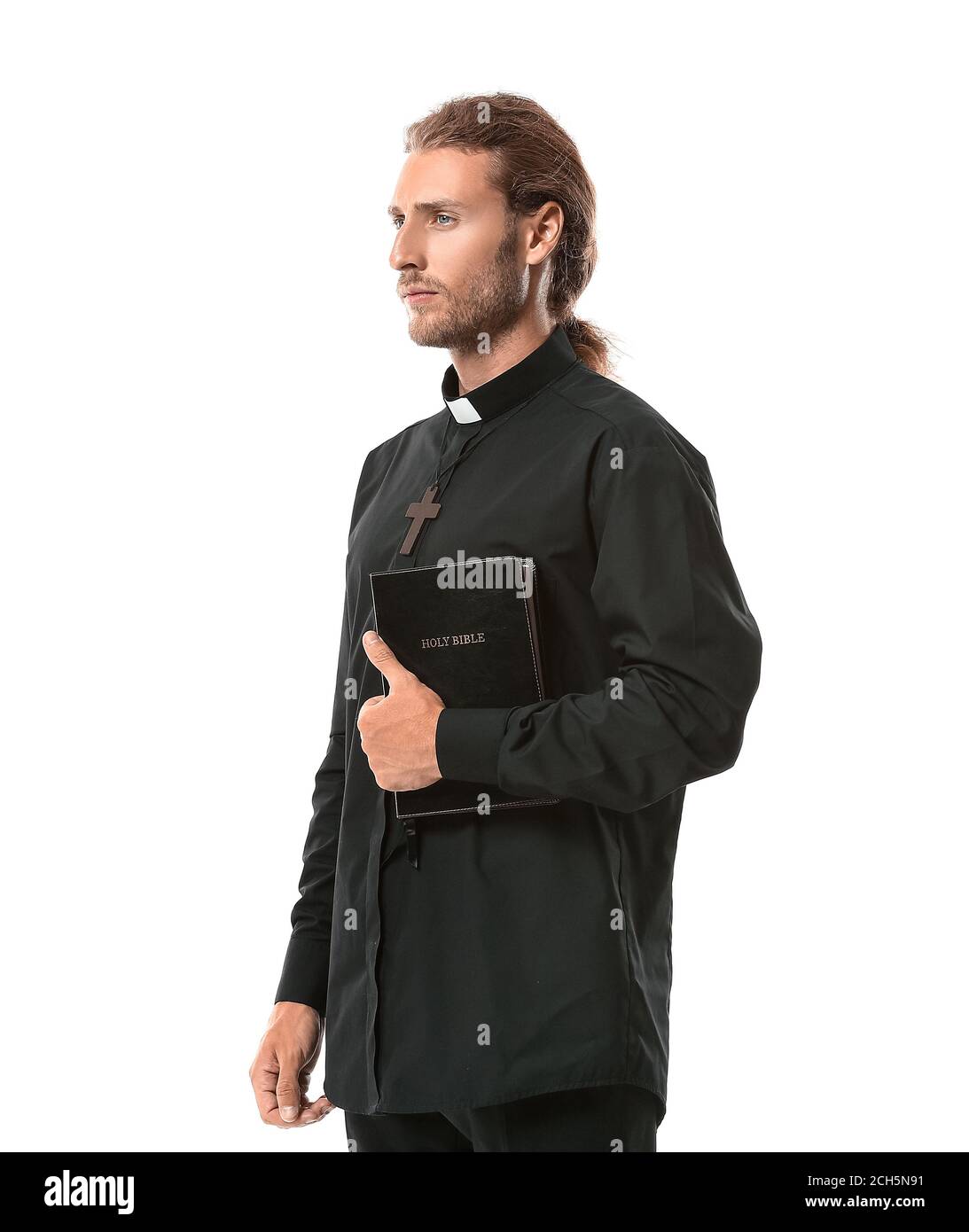 Handsome priest with Bible on white background Stock Photo - Alamy