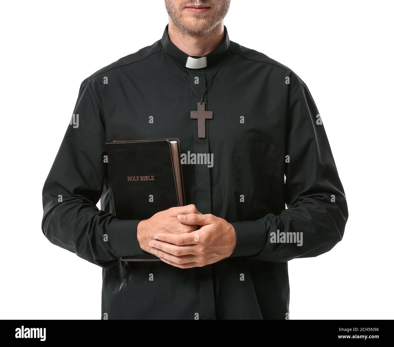 Handsome priest with Bible on white background Stock Photo - Alamy