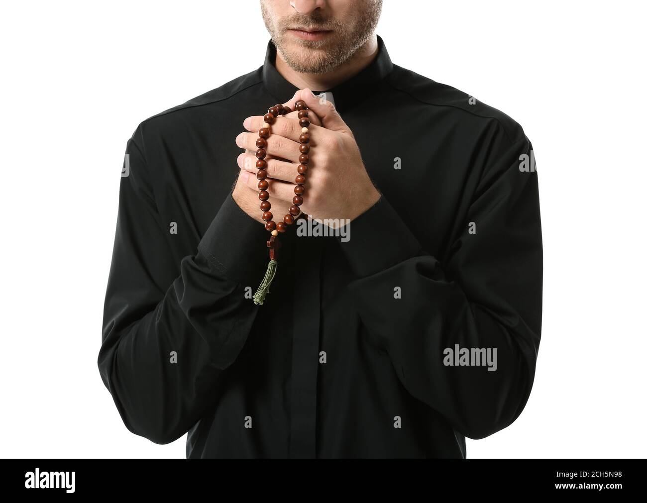 Handsome praying priest on white background Stock Photo - Alamy