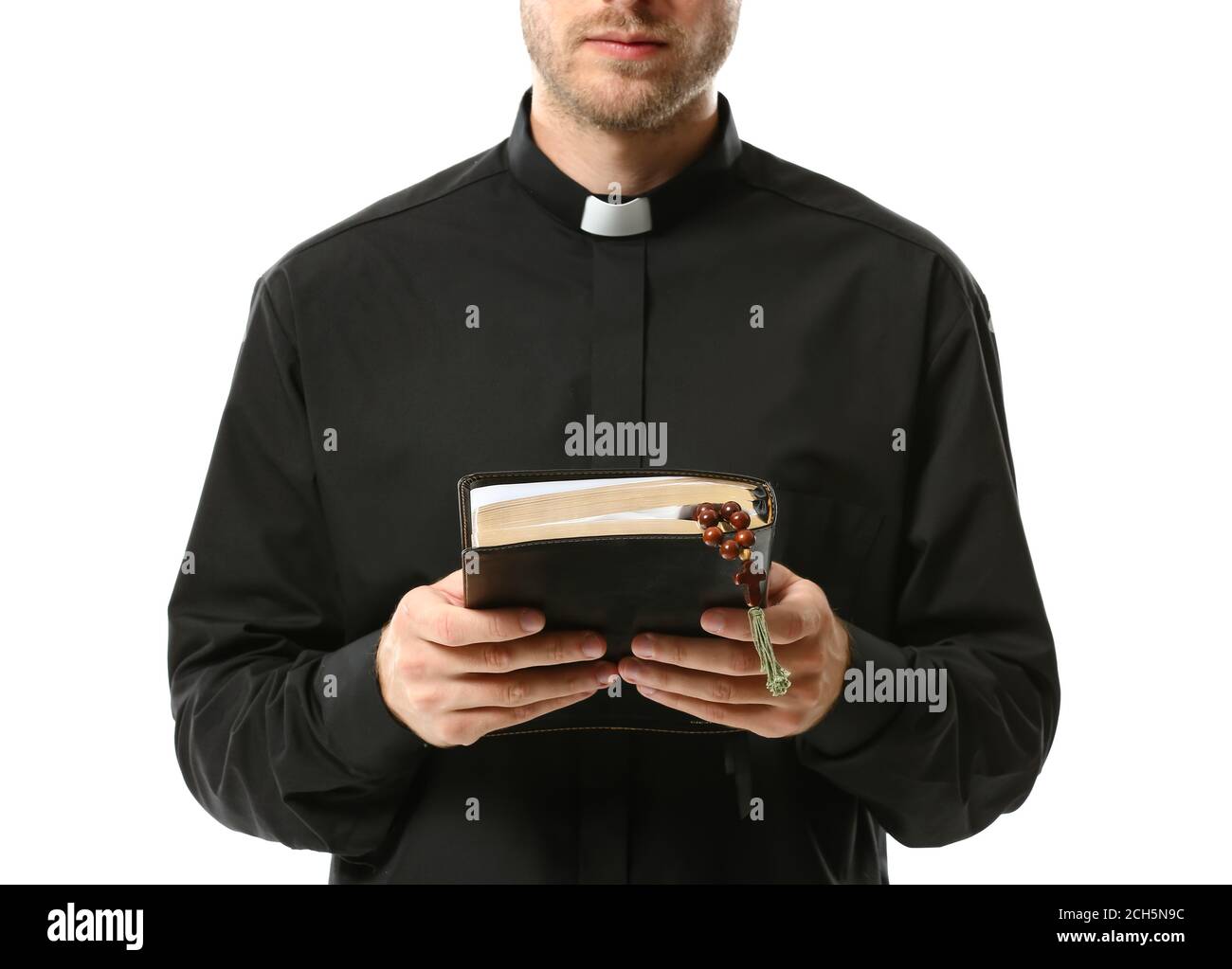Handsome priest with Bible on white background Stock Photo - Alamy