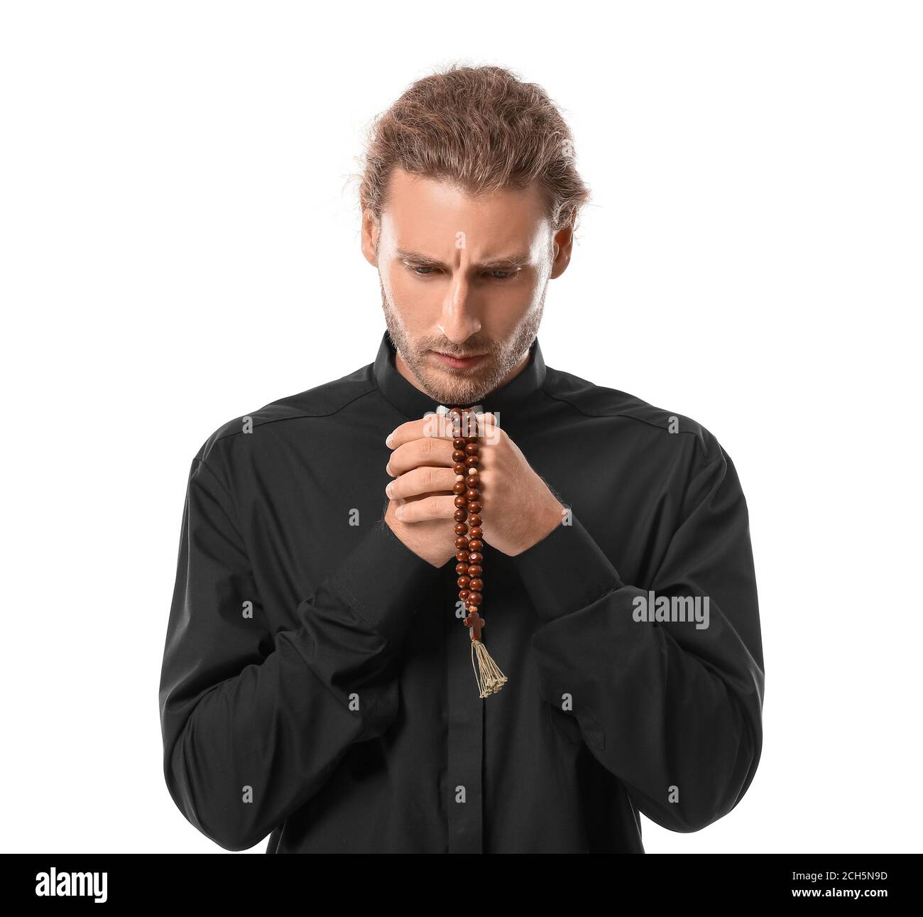 Handsome praying priest on white background Stock Photo - Alamy
