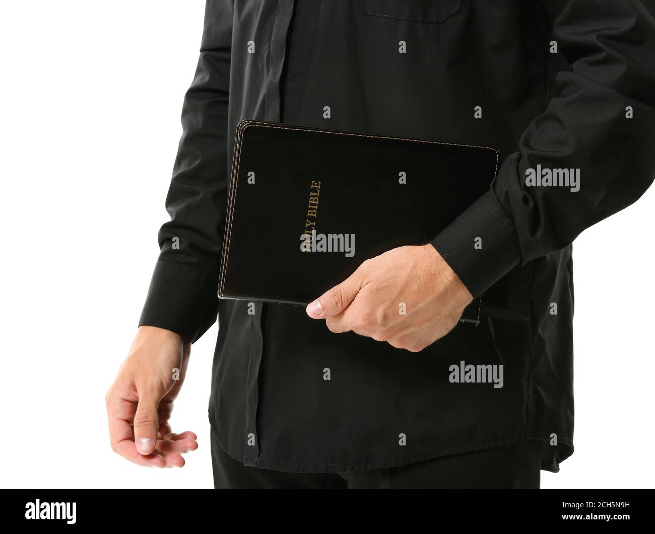 Handsome priest with Bible on white background Stock Photo - Alamy
