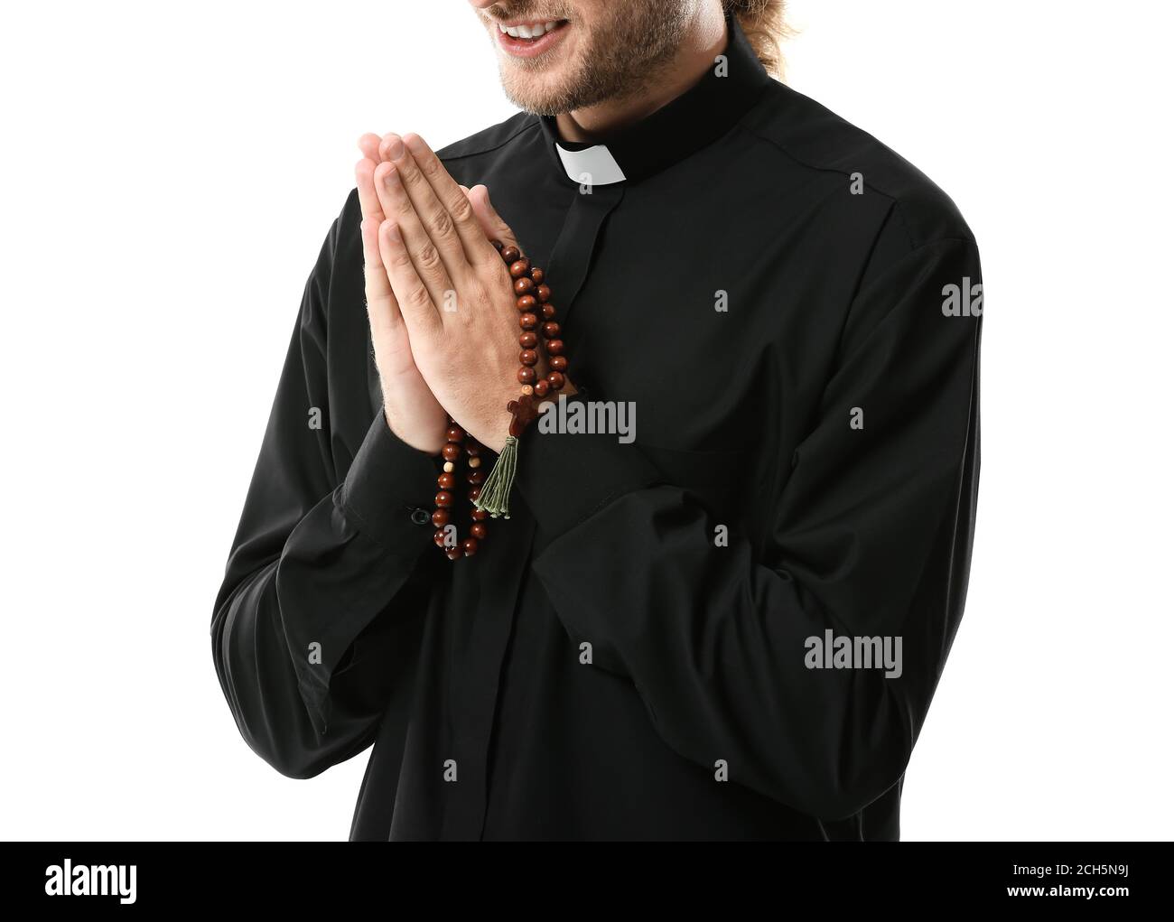 Handsome praying priest on white background Stock Photo - Alamy