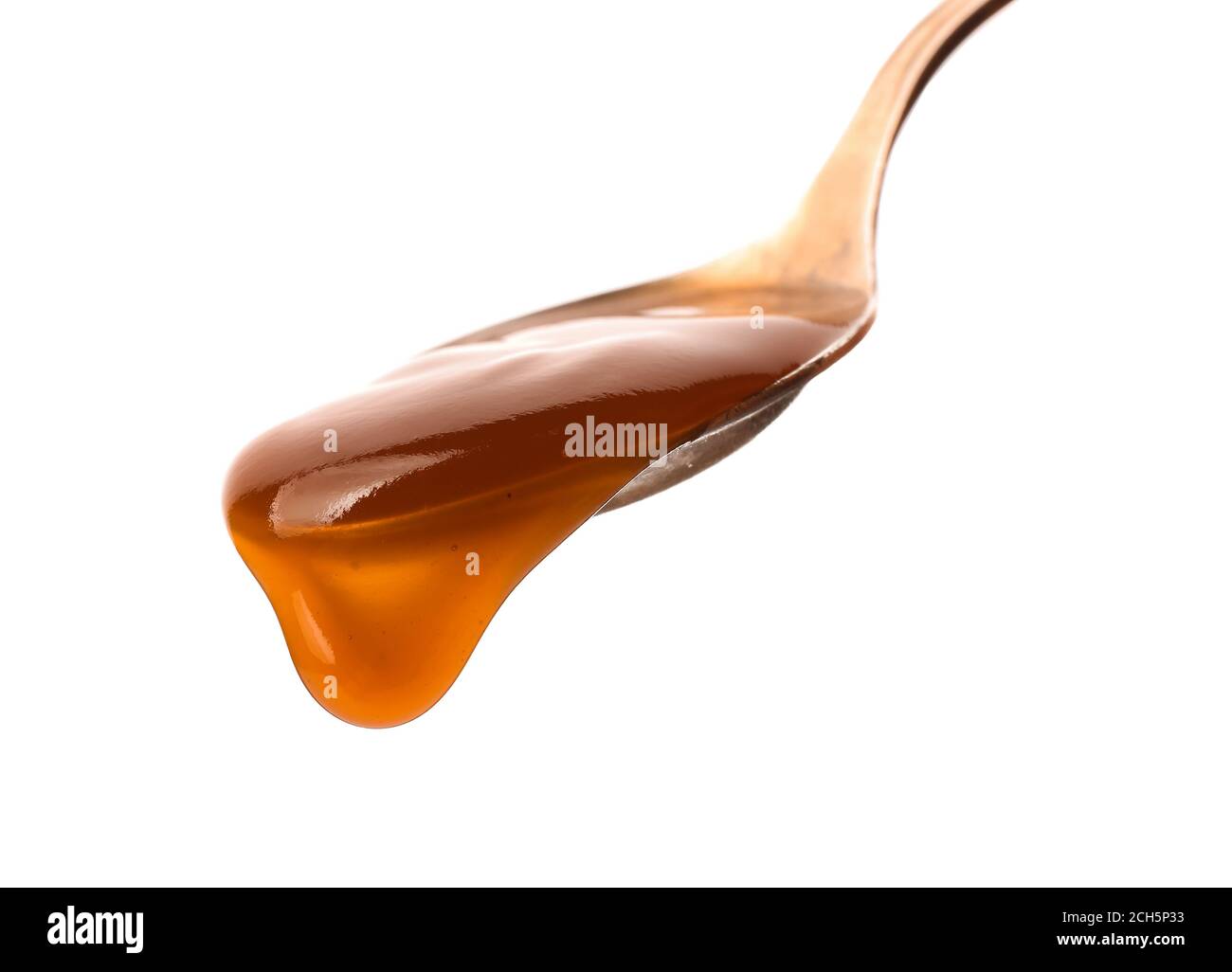 Spoon with liquid caramel on white background Stock Photo - Alamy