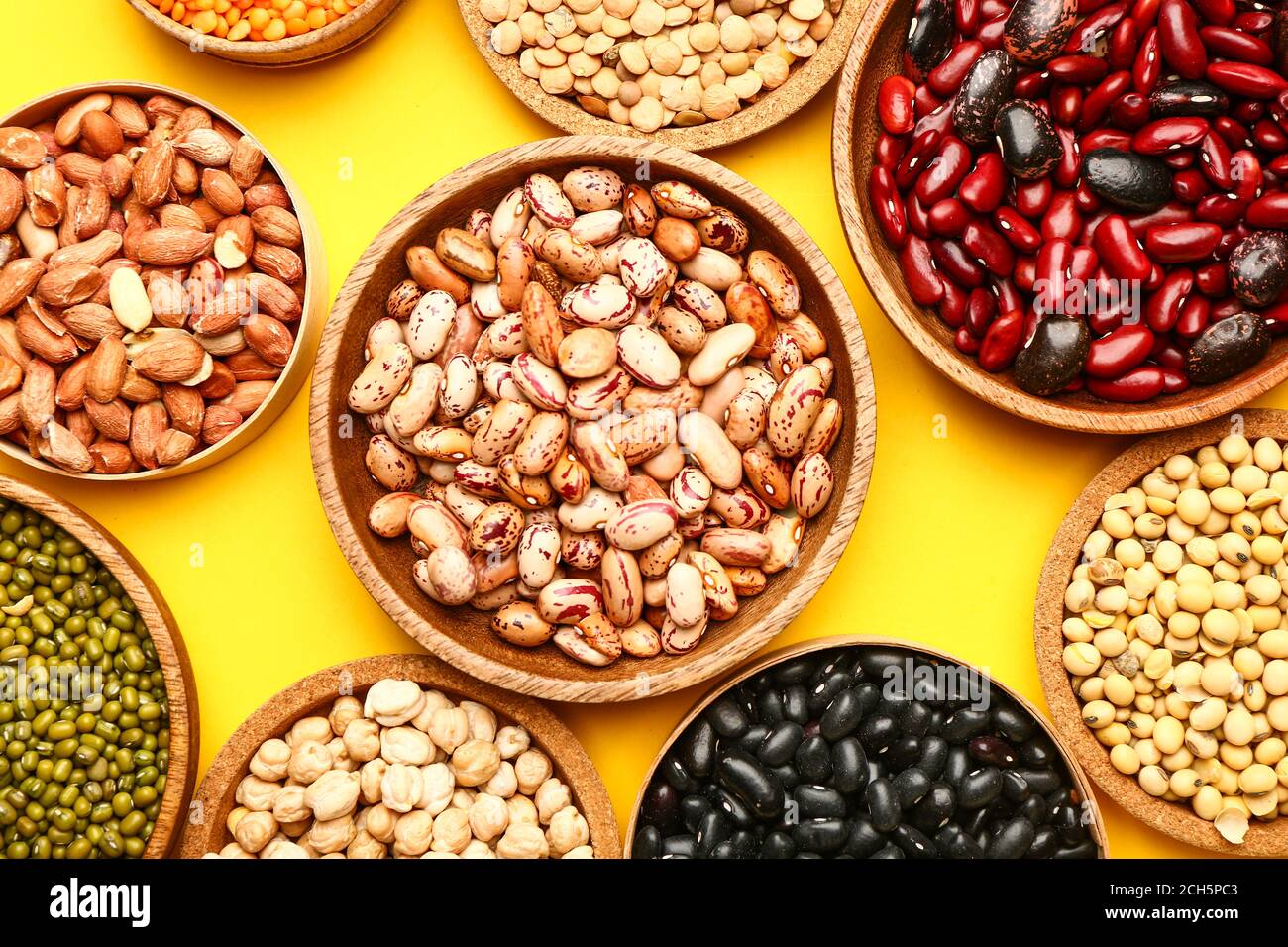 Different raw legumes on color background Stock Photo - Alamy