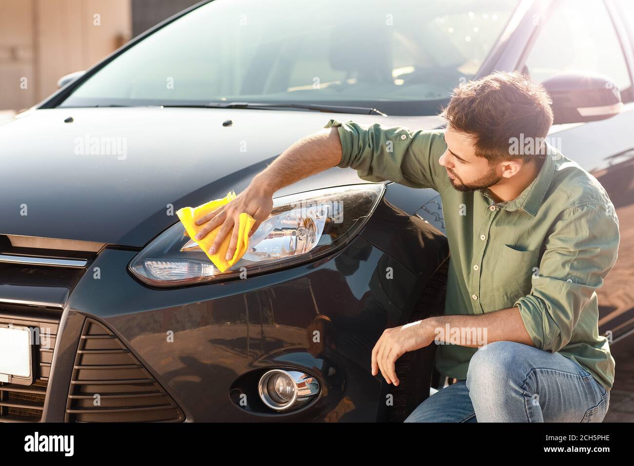 Man washing his car outdoors Stock Photo - Alamy