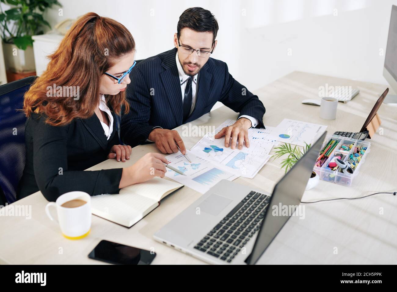 Marketing team checking documents Stock Photo - Alamy