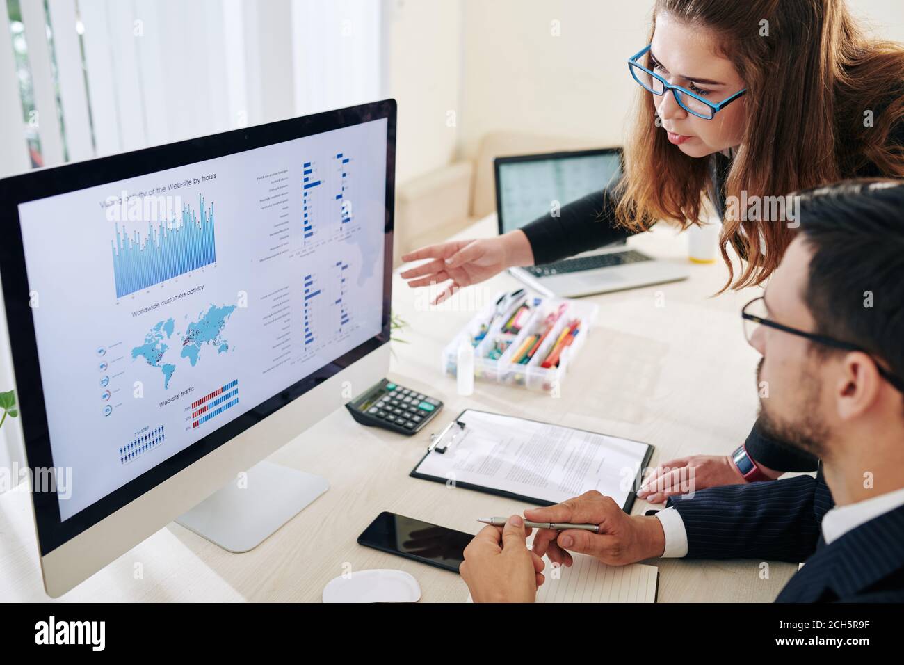 Business people discussing statistics Stock Photo - Alamy