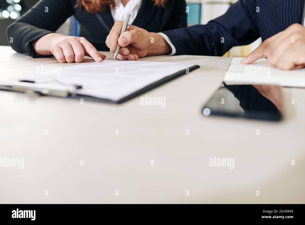 Business people signing document Stock Photo - Alamy