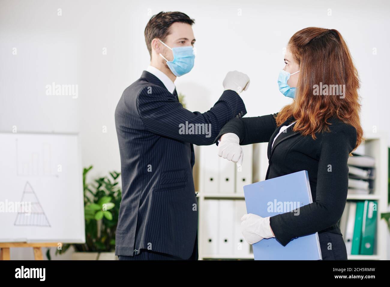 Business people doing elbow bump Stock Photo - Alamy