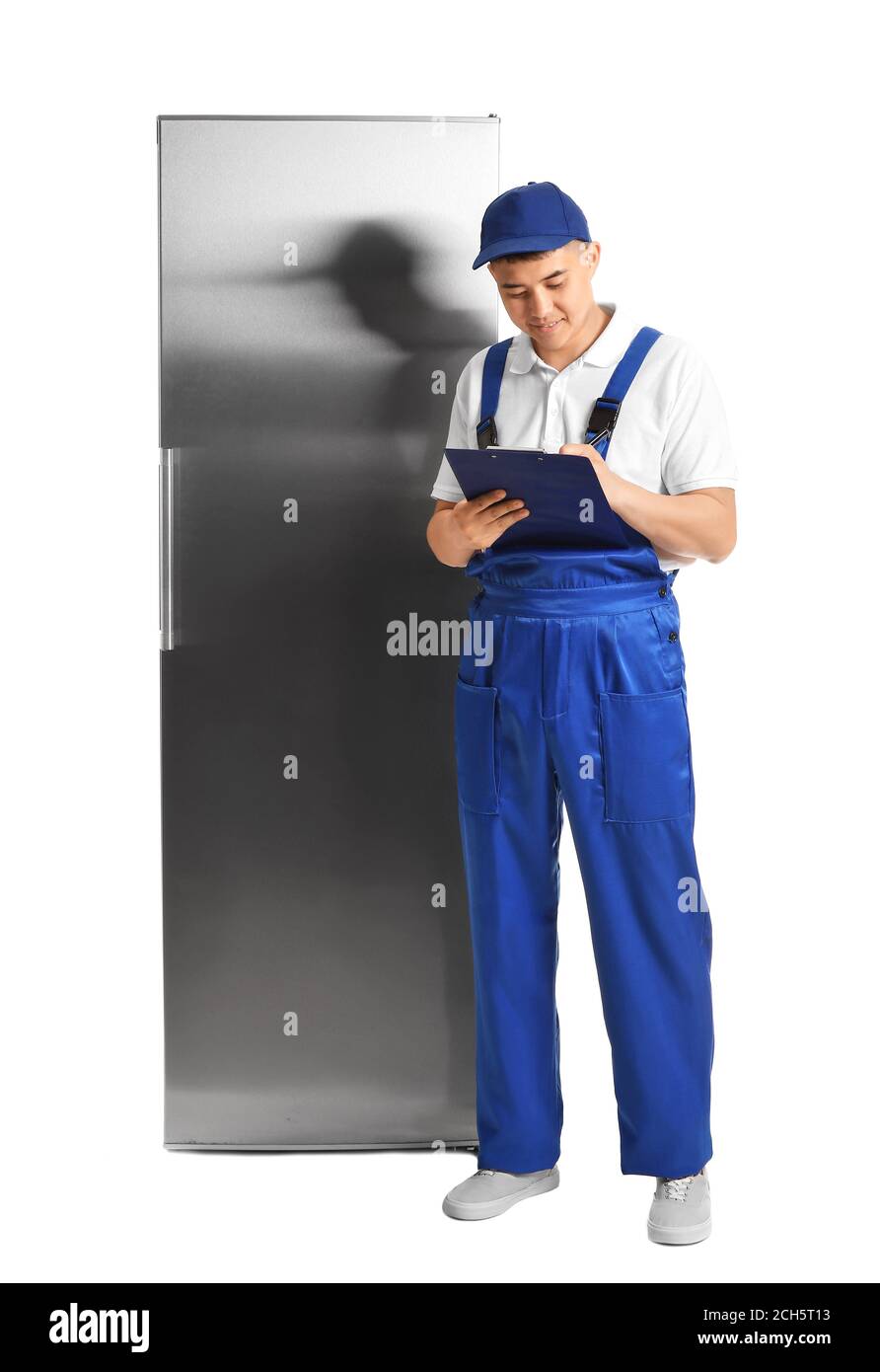 Worker of repair service near fridge on white background Stock Photo ...