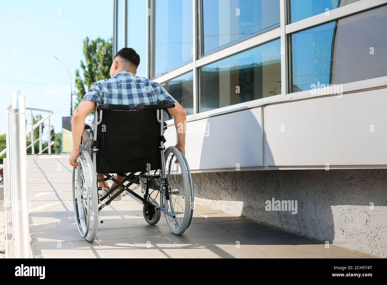 Young man in wheelchair on ramp outdoors Stock Photo - Alamy