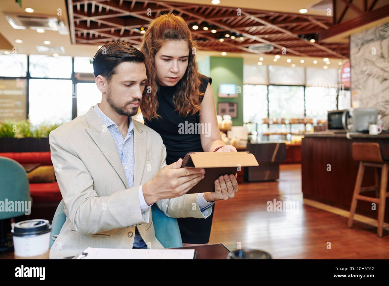Business people reading article Stock Photo - Alamy